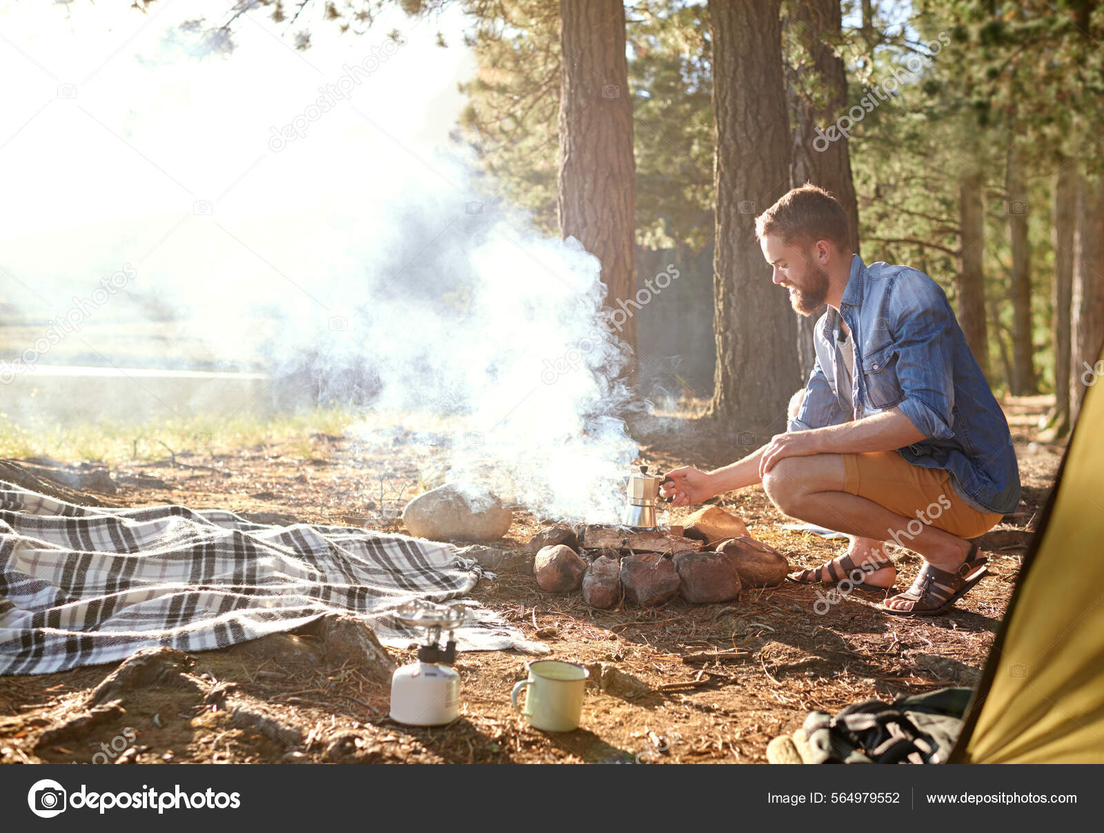 Person Tending Camp Fire