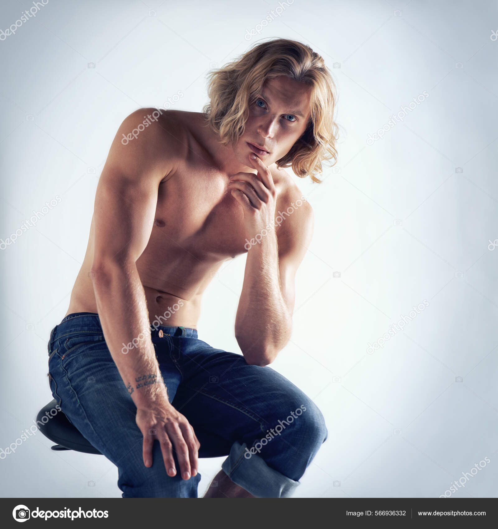 The Thinker. Portrait of a handsome young man sitting shirtless on a stool. — Stock Photo ...