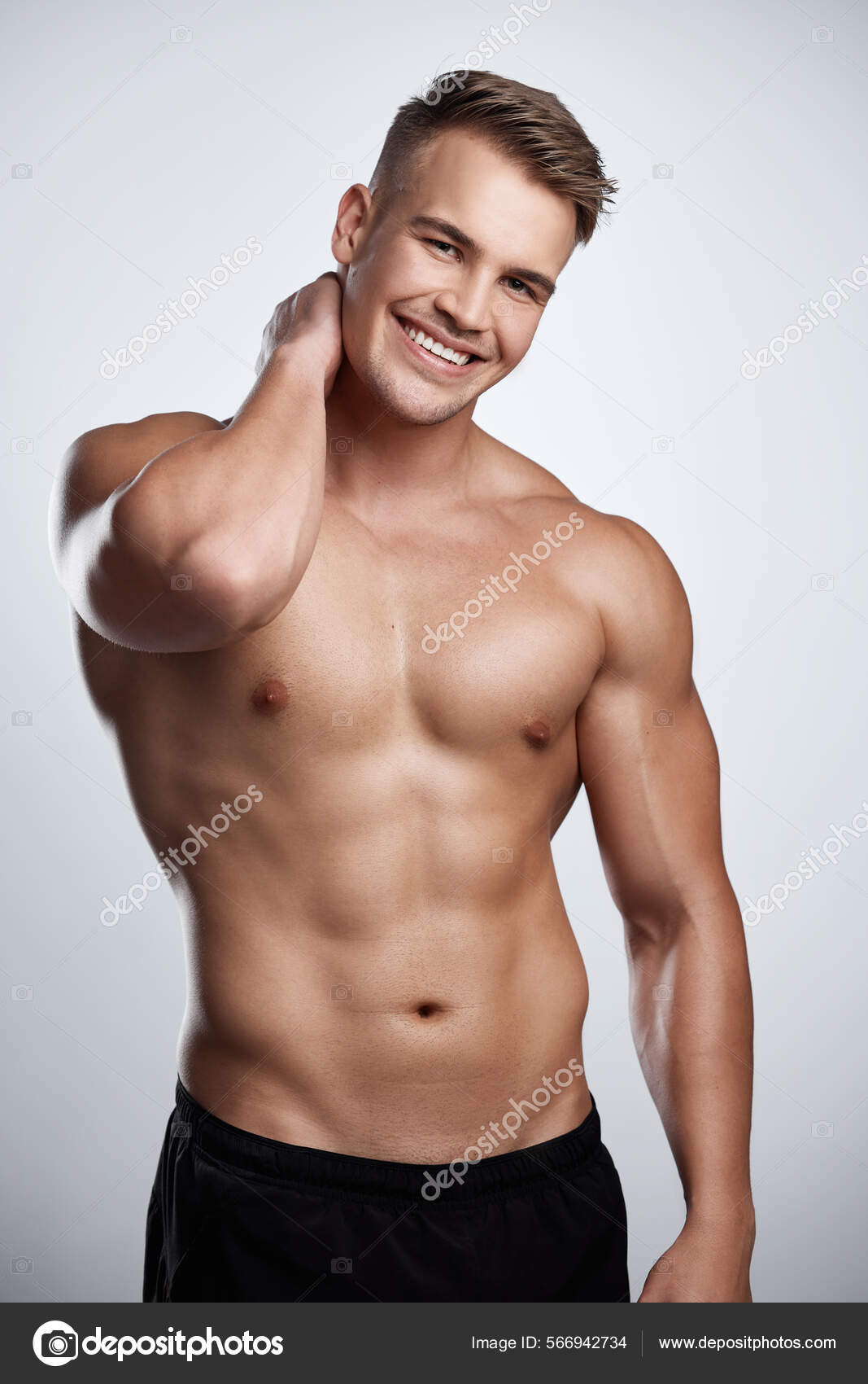 I look good in muscles. Studio portrait of a muscular young man posing ...