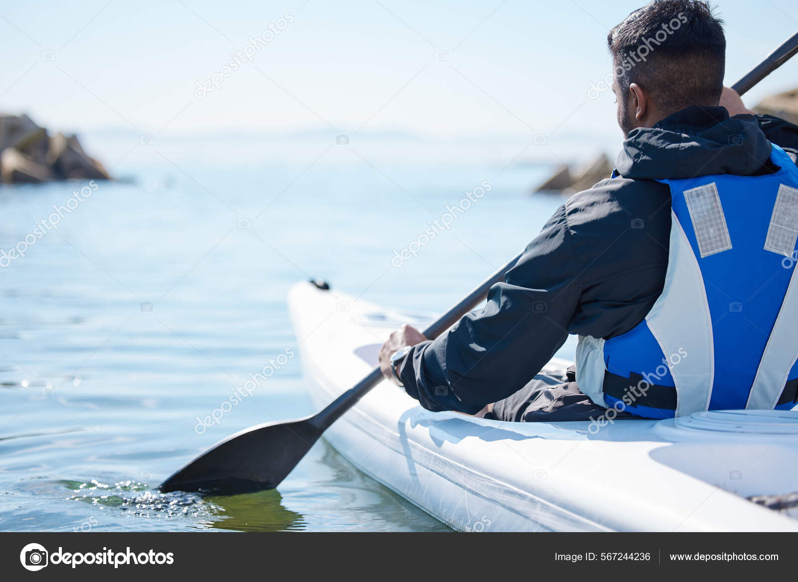Open water is a highway to adventure. Rearview shot of a young man ...