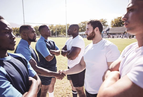 Two opponent rugby teams shaking hands before or after a match outside ...