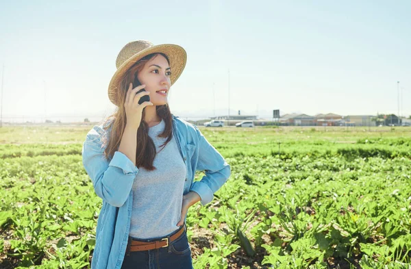 a young female farmer using her phone to make a call. - Stock Image ...
