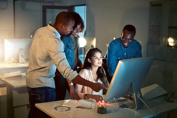 Collaborating on their latest task. a group of colleagues working late ...