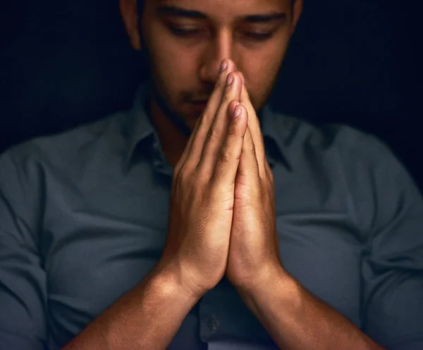 Give us this day our daily bread. Closeup shot of a young man praying ...