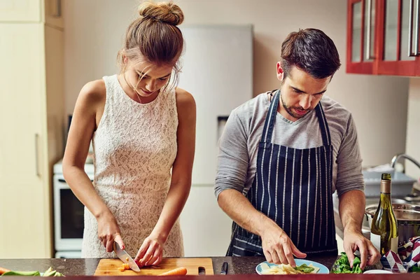 Cooking with love provides food for the soul. a young couple preparing ...