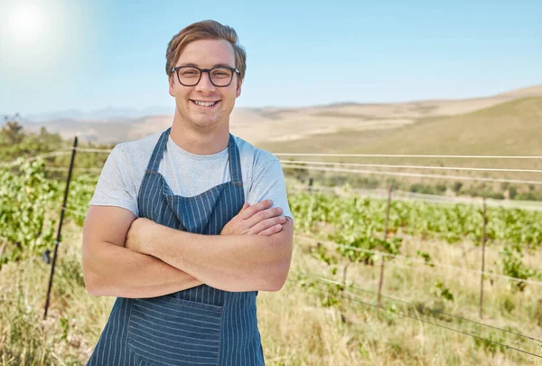 Vineyard and happy farmer man in the countryside with smile at a farm ...