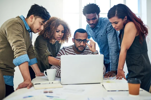 Teamwork can solve almost any problem. a group of colleagues using a ...