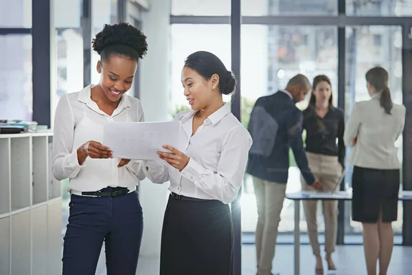 She loves to see her ideas come alive on paper. two female work ...
