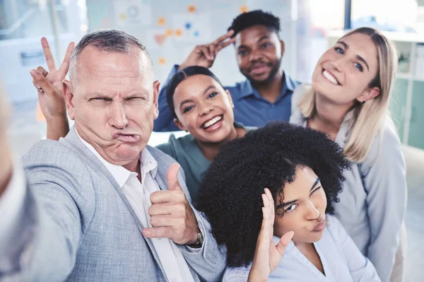 Creative, fun and business team taking a selfie together while in a ...