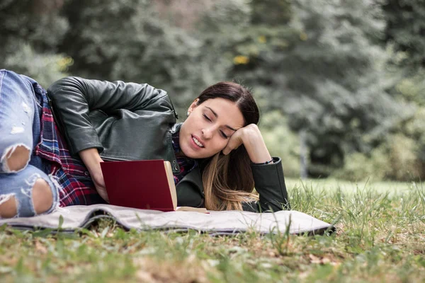 Woman Reading Book While Laying Grass Outdoors Park Stock Photo by ...