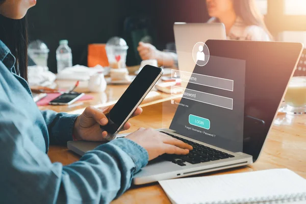 Person hand typing on keyboard with login and password on screen ...