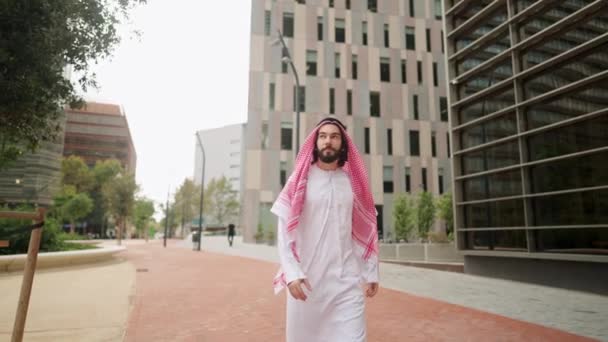 Successful arab man sheikh in traditional clothes looking at ...