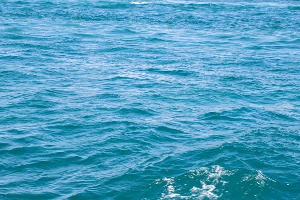Sea surface. Turquoise sea water. Close up blue water surface at deep ...