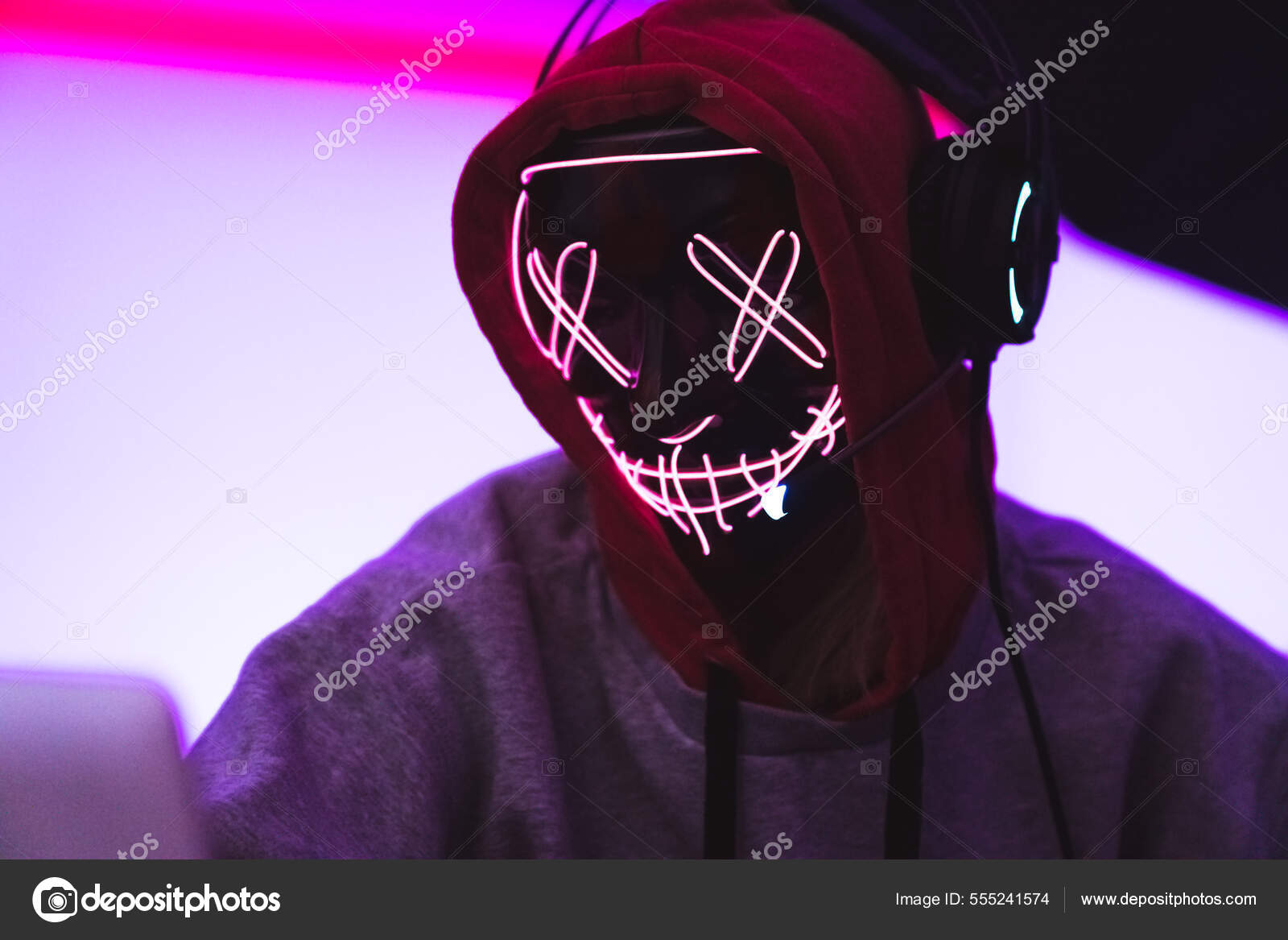 Cyber safety concept. Anonymous hacker in a scary mask wearing ...