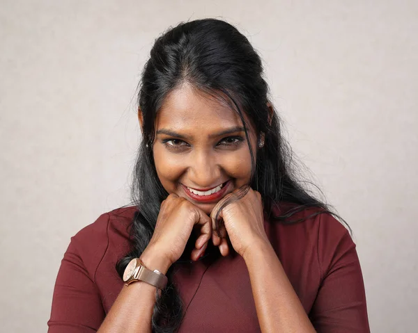 Asian Indian origin dark skin tone beautiful woman facial hand expression witty smile hand on ...