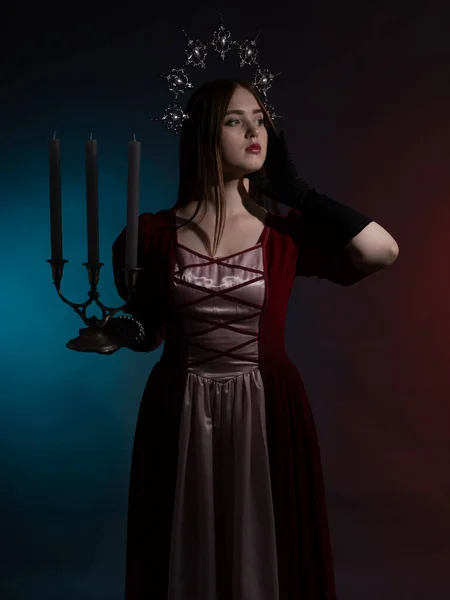 Mythical fantasy queen with a candlestick. Silvery gothic crown on the ...