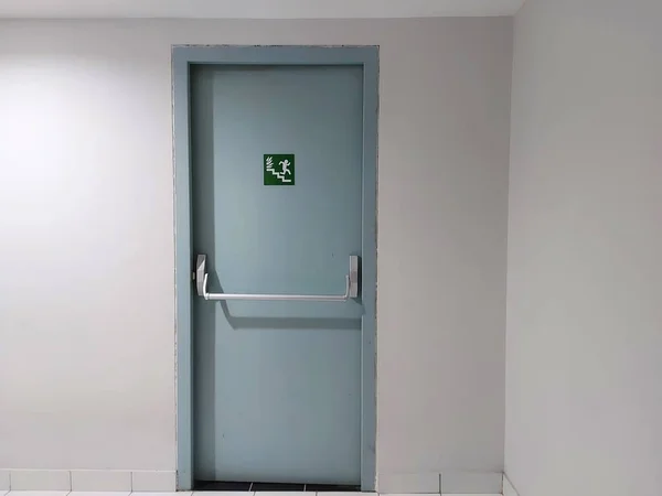emergency door closed. equipped with a sign for people running down the ...