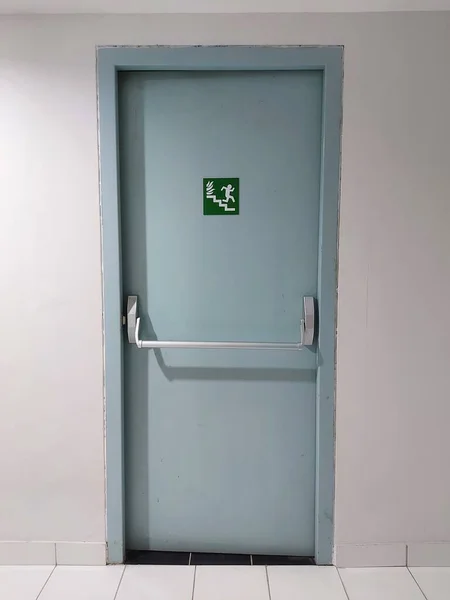 emergency door closed. equipped with a sign for people running down the ...