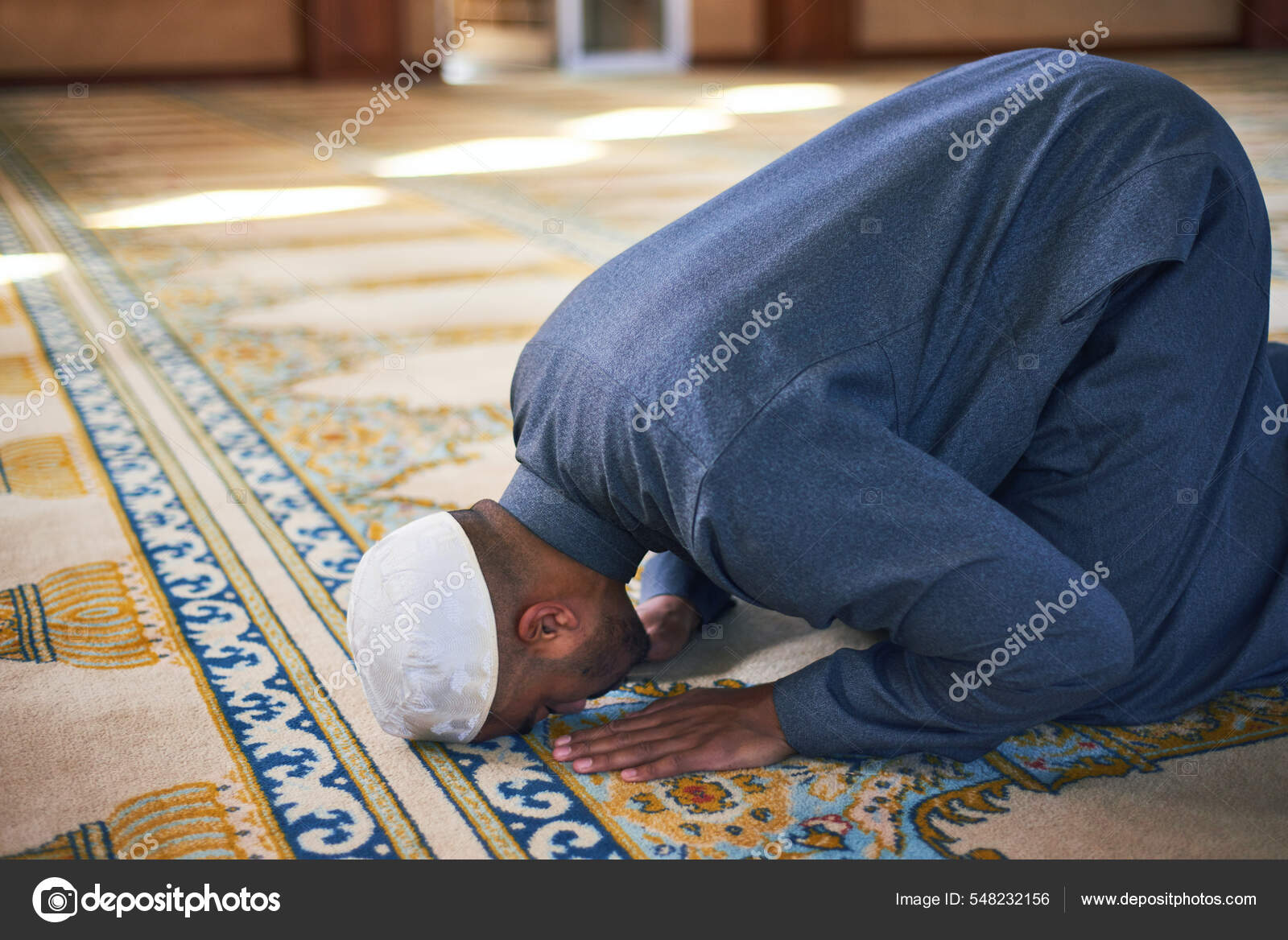 A young Muslim man prostrate during prayers in a mosque Stock Photo by ...