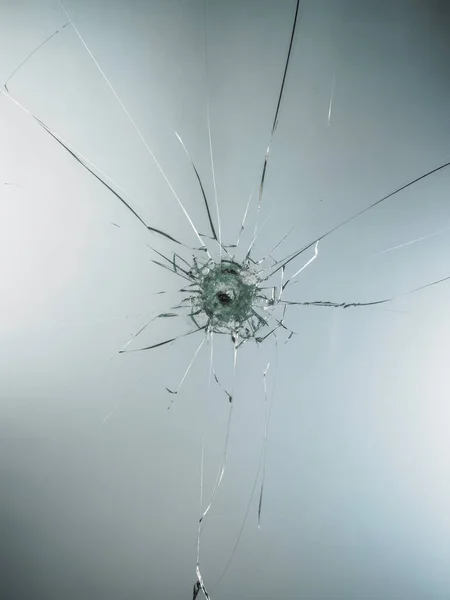 broken cracked glass with hole over white background - Stock Image ...