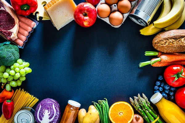 Large variety of food making a frame on black background - Stock Image ...