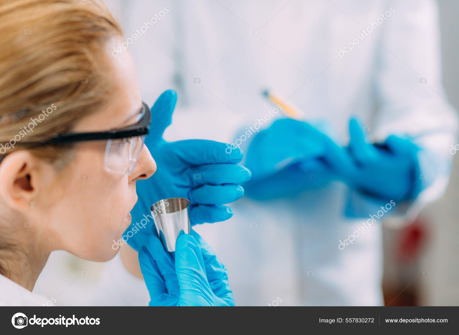 Female Scientists Smelling Sample Test Cup Stock Photo by ©microgen ...