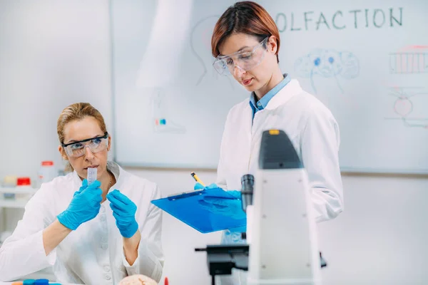 Olfactory Test Female Scientists Smelling Sample Test Tube Taking Notes ...