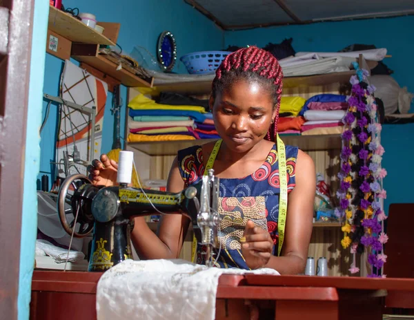 A happy female African Nigerian tailor, fashion designer, business ...