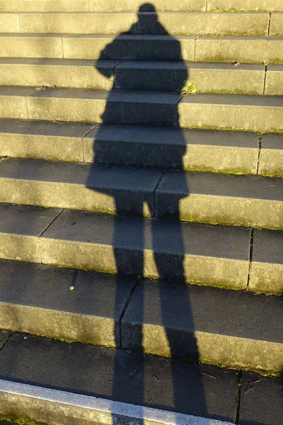 Light and shadow play, steep concrete stairs, shadow cast of me as ...