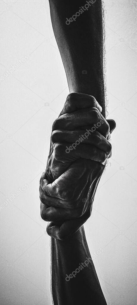 A grayscale shot of strong arms holding each other-bond, union, brotherhood