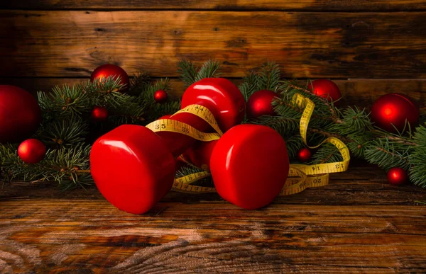 Two red dumbbells with tape measure (measuring tape), Christmas tree ...