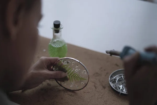 Stained glass maker works with colorful souvenirs. Female hands ...