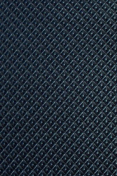 Close-up of diamond-patterned textured synthetic fabric used to make ...
