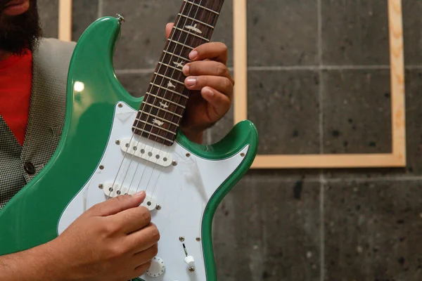 Strings of an electric guitar being played by a musician. Detailed plan ...