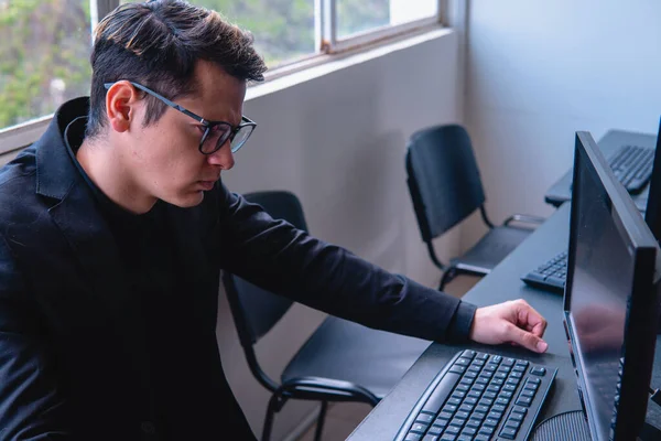 Office worker watching his computer annoyed. Worker looking at computer ...
