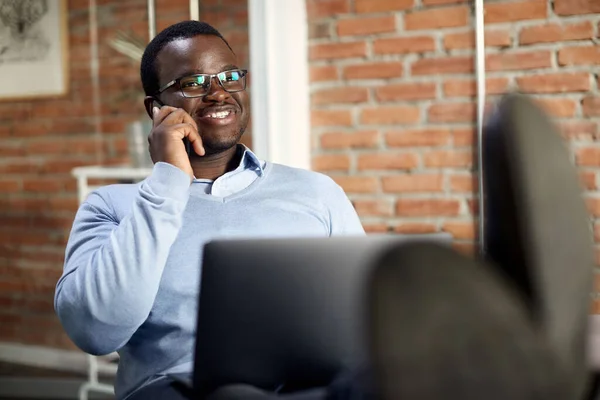 Happy African American businessman making a phone call over mobile ...