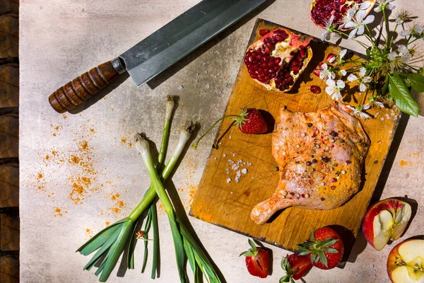 Raw marinated duck shank with leeks, strawberries, apple, pomegranate ...