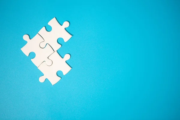White part of jigsaw puzzle pieces on blue background. concepts of problem solving, business ...