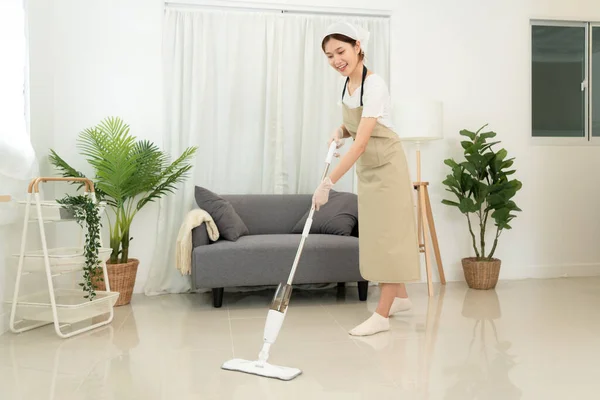 Housekeeper is use mop with vacuum cleaner to housekeeping with ...