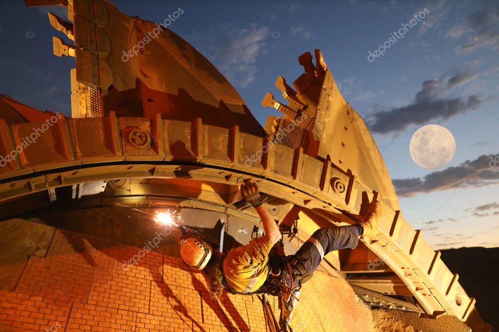 Rope access welder maintenance abseiler wearing fall safety body ...