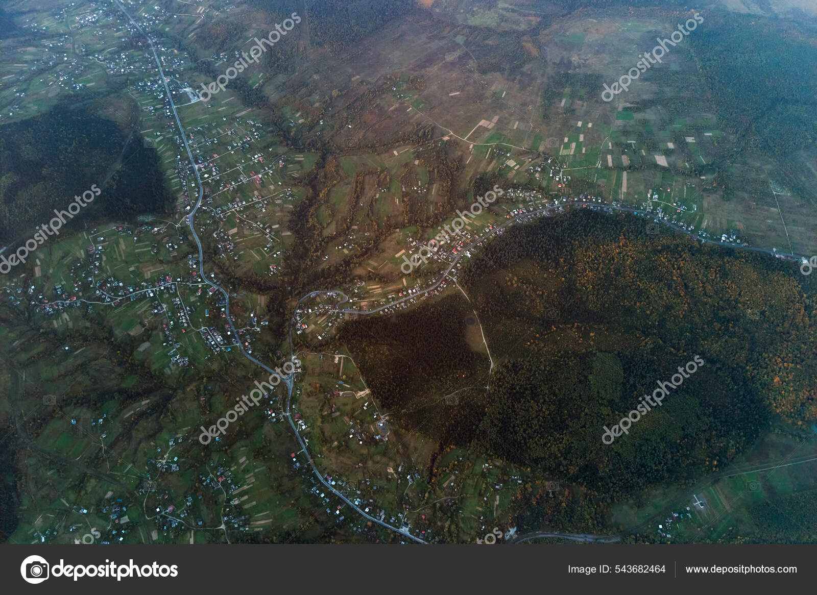 Aerial view from high altitude of distant scattered houses in rural ...