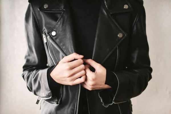 Woman leather jacket design concept on hanger holding. Woman in black ...