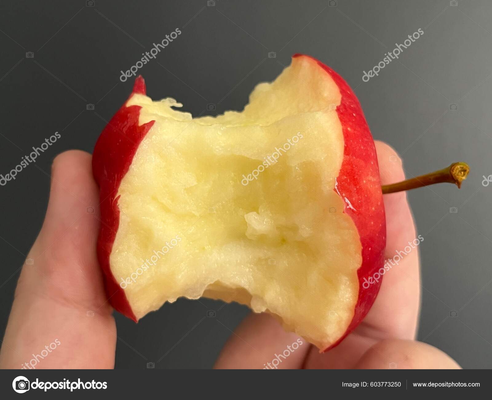 Bitten Red Apple Hand Stock Photo by ©creuxnoir 603773250