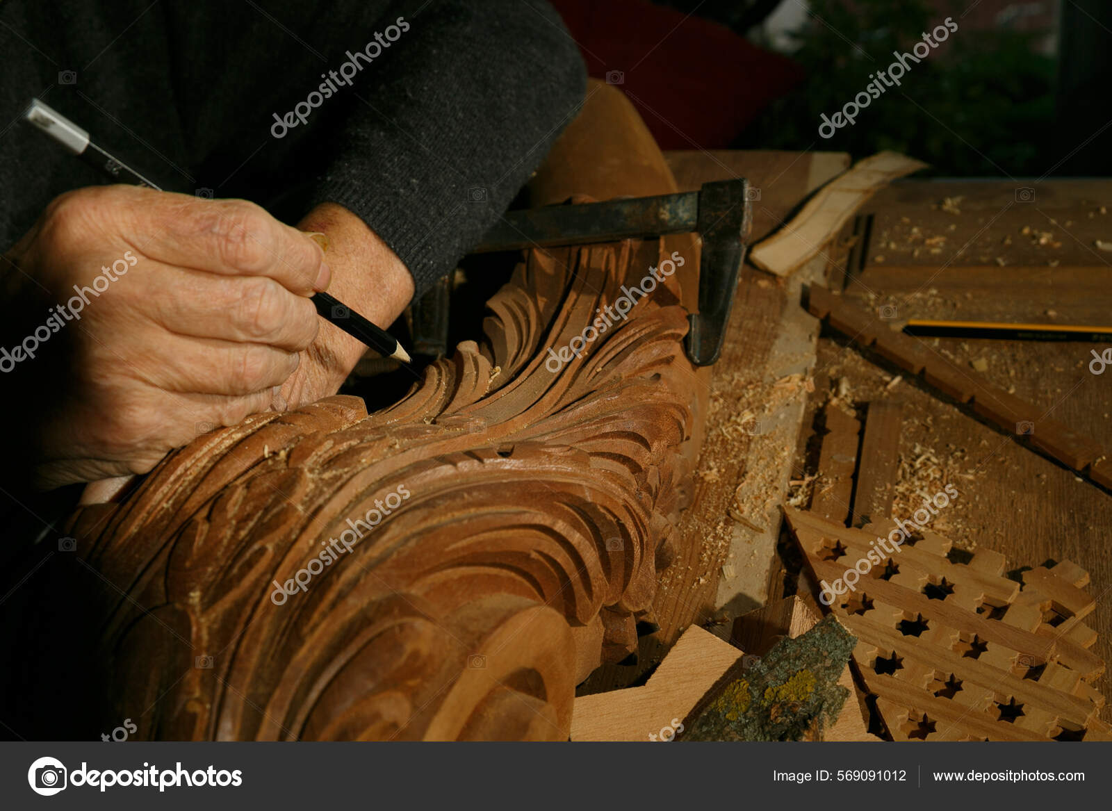 Craftsmans hands working on wood carving, with gouge and chisel ...