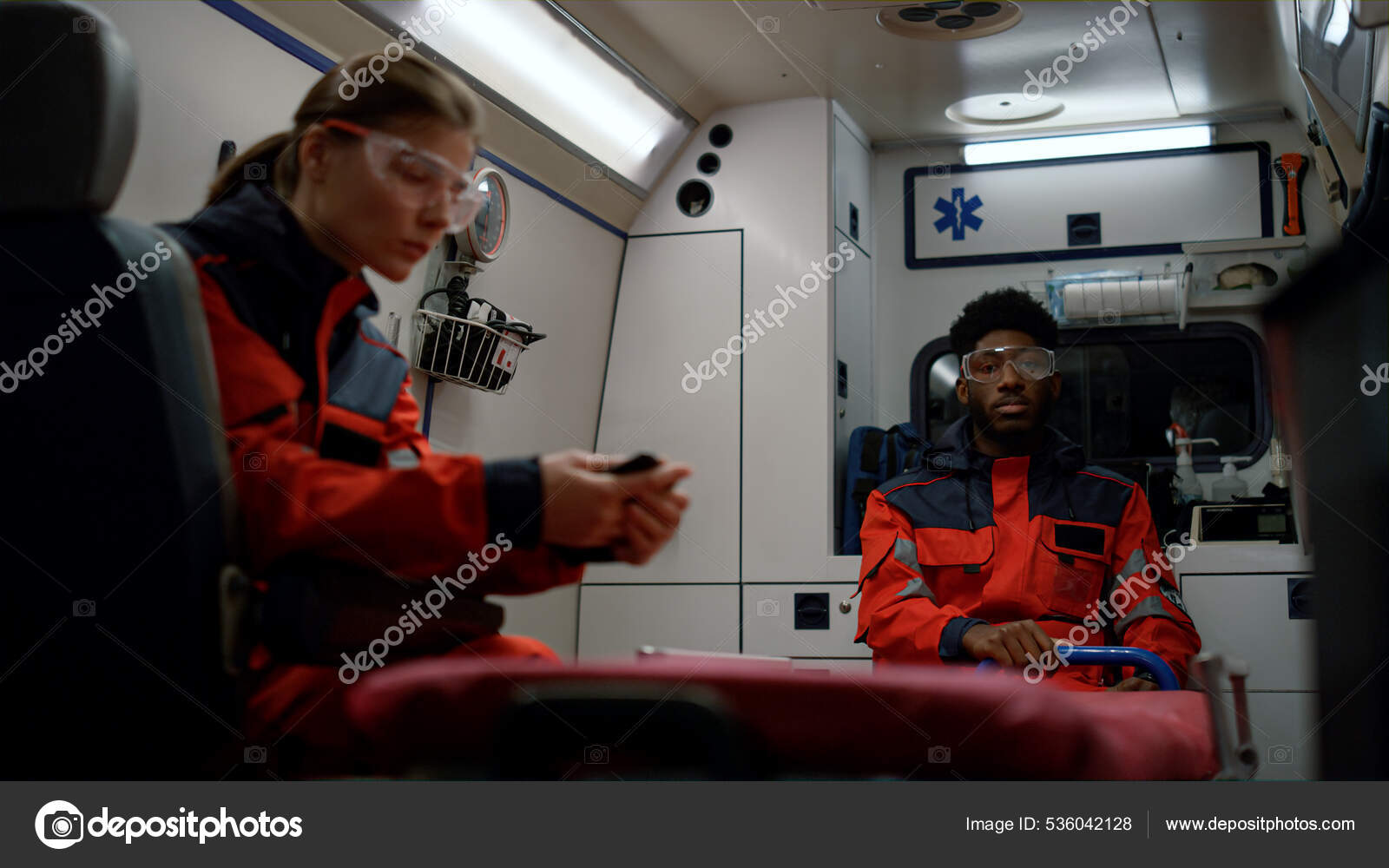 Emergency care assistants driving on 911 call in ambulance car — Stock ...