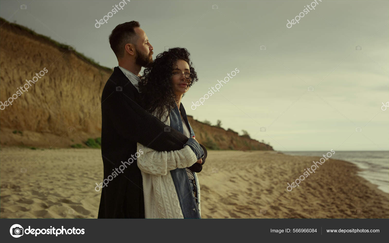 Couple cuddling beach sea on holiday. Happy mixed race lovers hug at ...