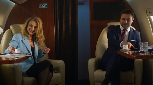 Business class passengers flying corporate jet. Successful partners ...