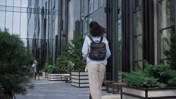 Office manager riding electric scooter rear view. Corporate lifestyle ...