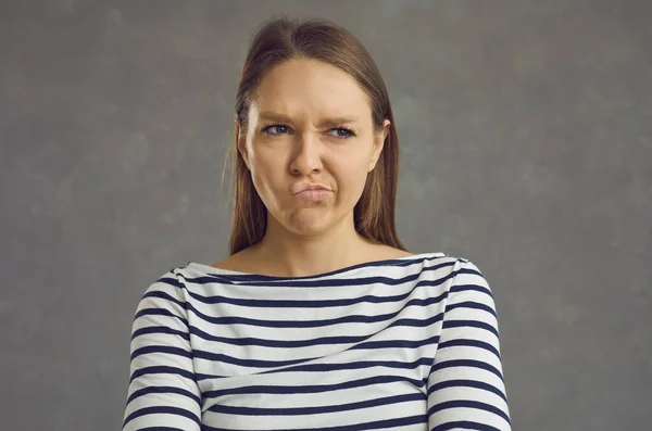 Portrait of a funny upset depressed young woman crying and looking at ...