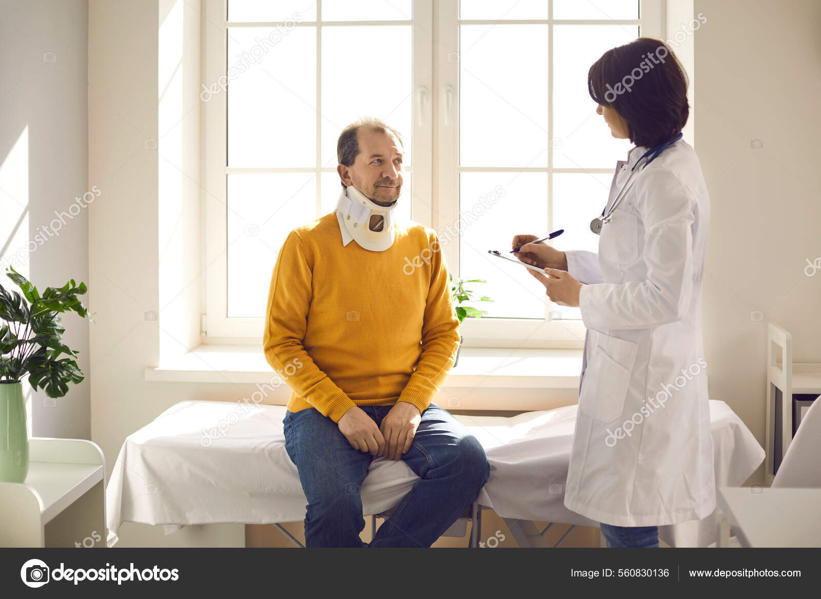 Senior patient wearing a cervical collar listening to his doctor at the ...